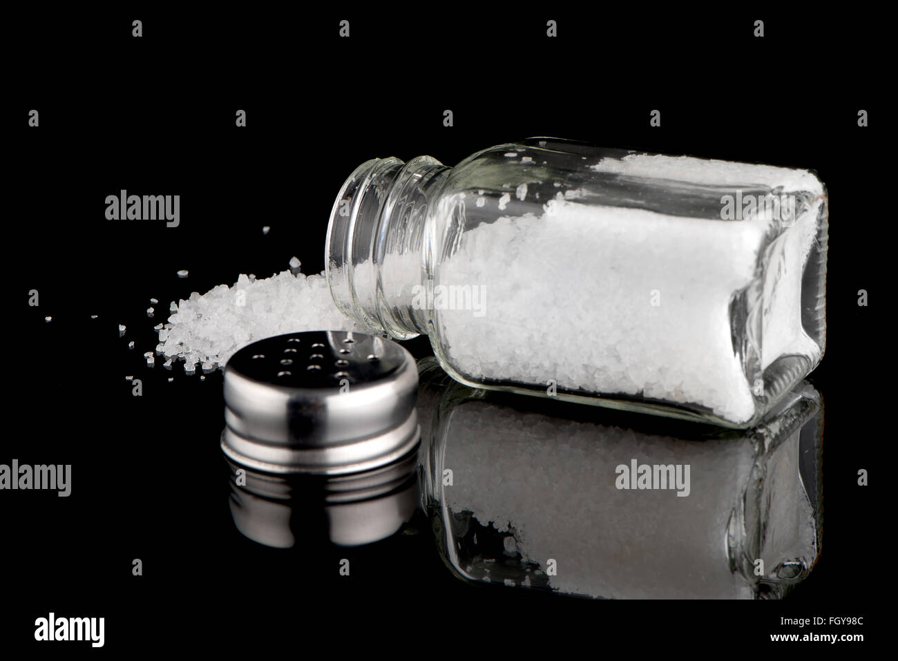 Salt shaker on black Background Stock Photo - Alamy