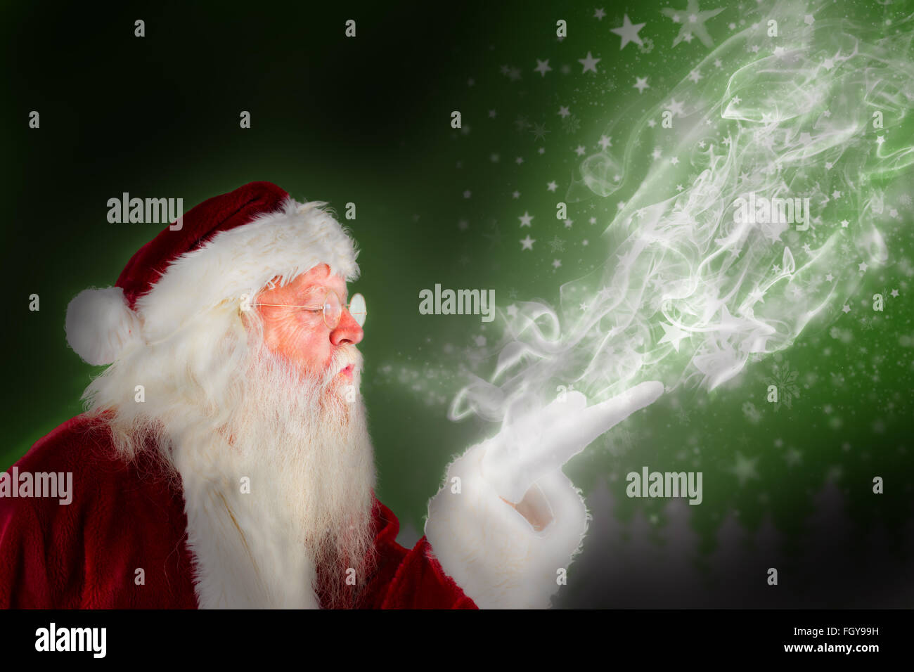 Composite image of santa claus blowing Stock Photo - Alamy
