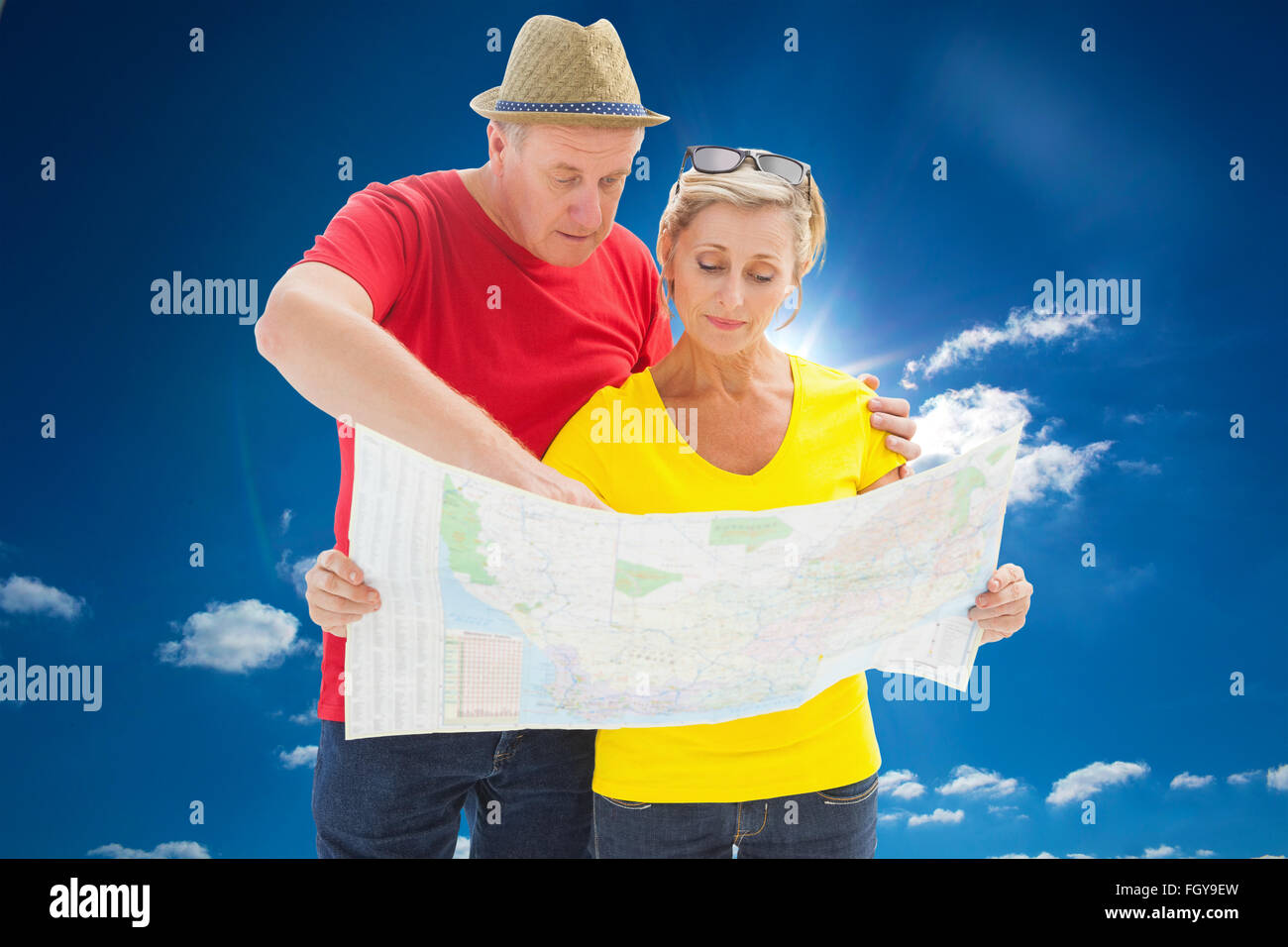Composite image of lost tourist couple using map Stock Photo - Alamy