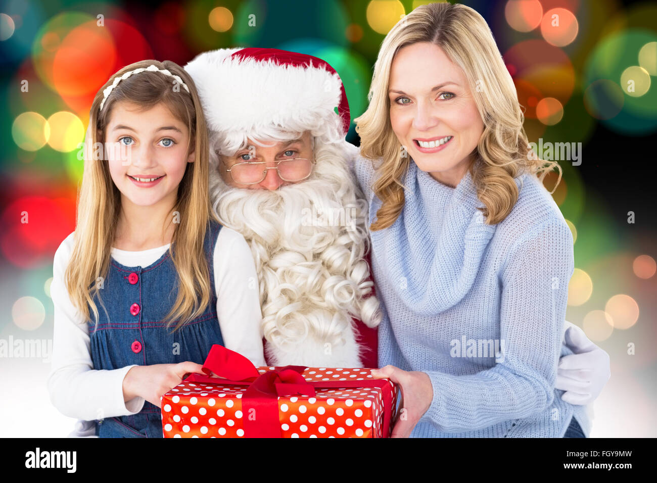 Composite image of mother and daughter with santa claus Stock Photo - Alamy