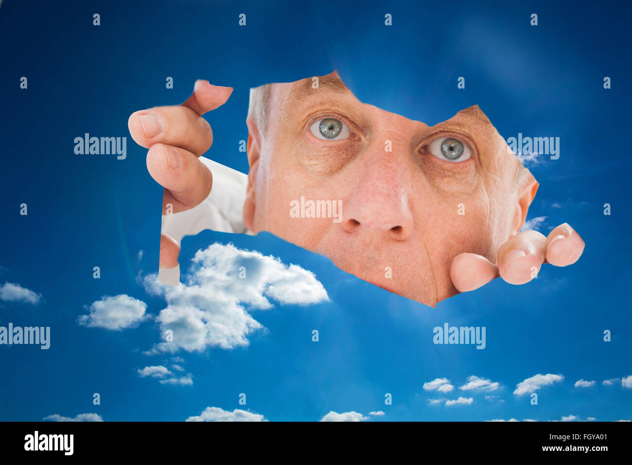 Man looking through ripped paper hole hi-res stock photography and ...