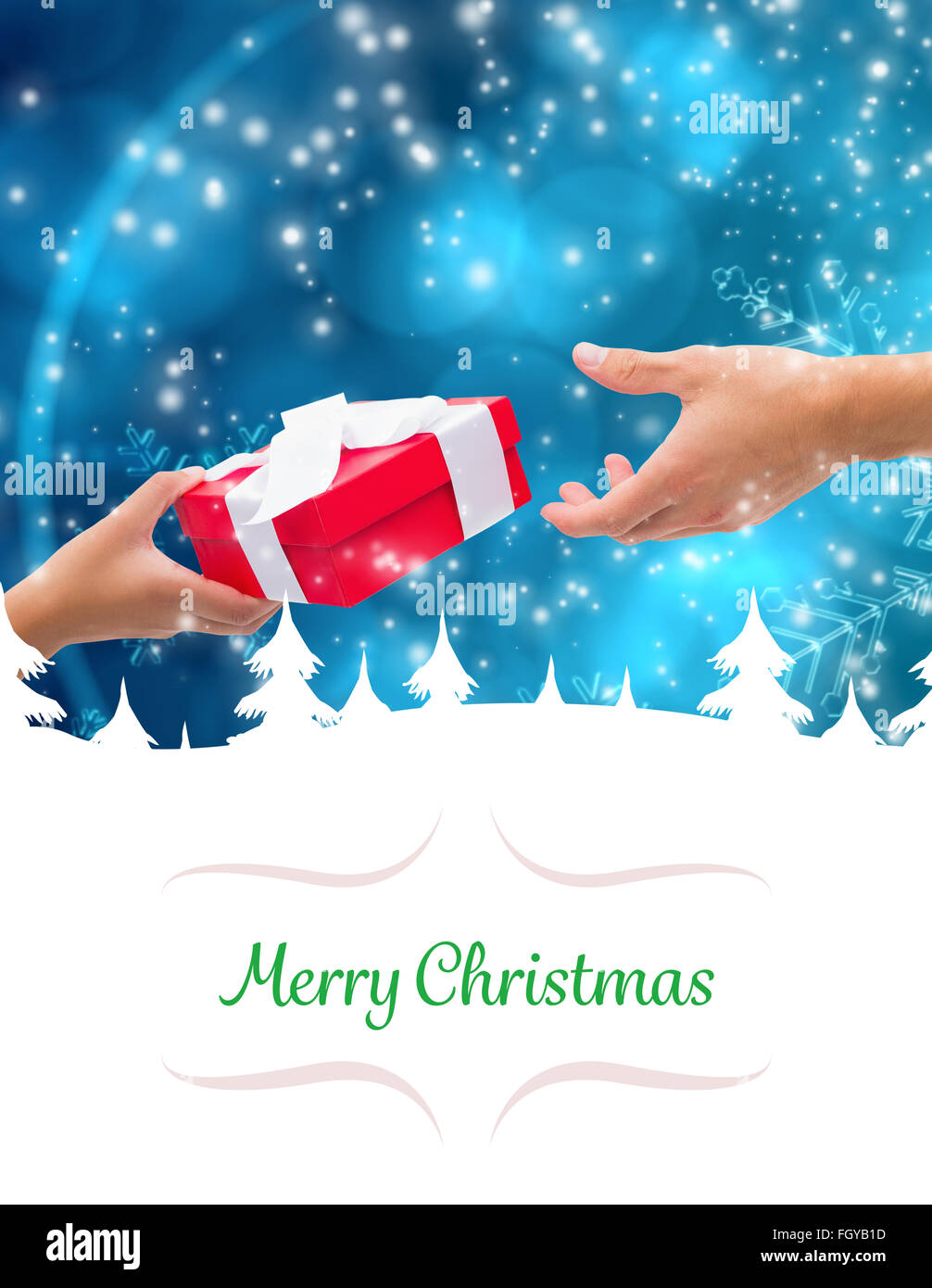 Composite image of couple passing a wrapped gift Stock Photo - Alamy