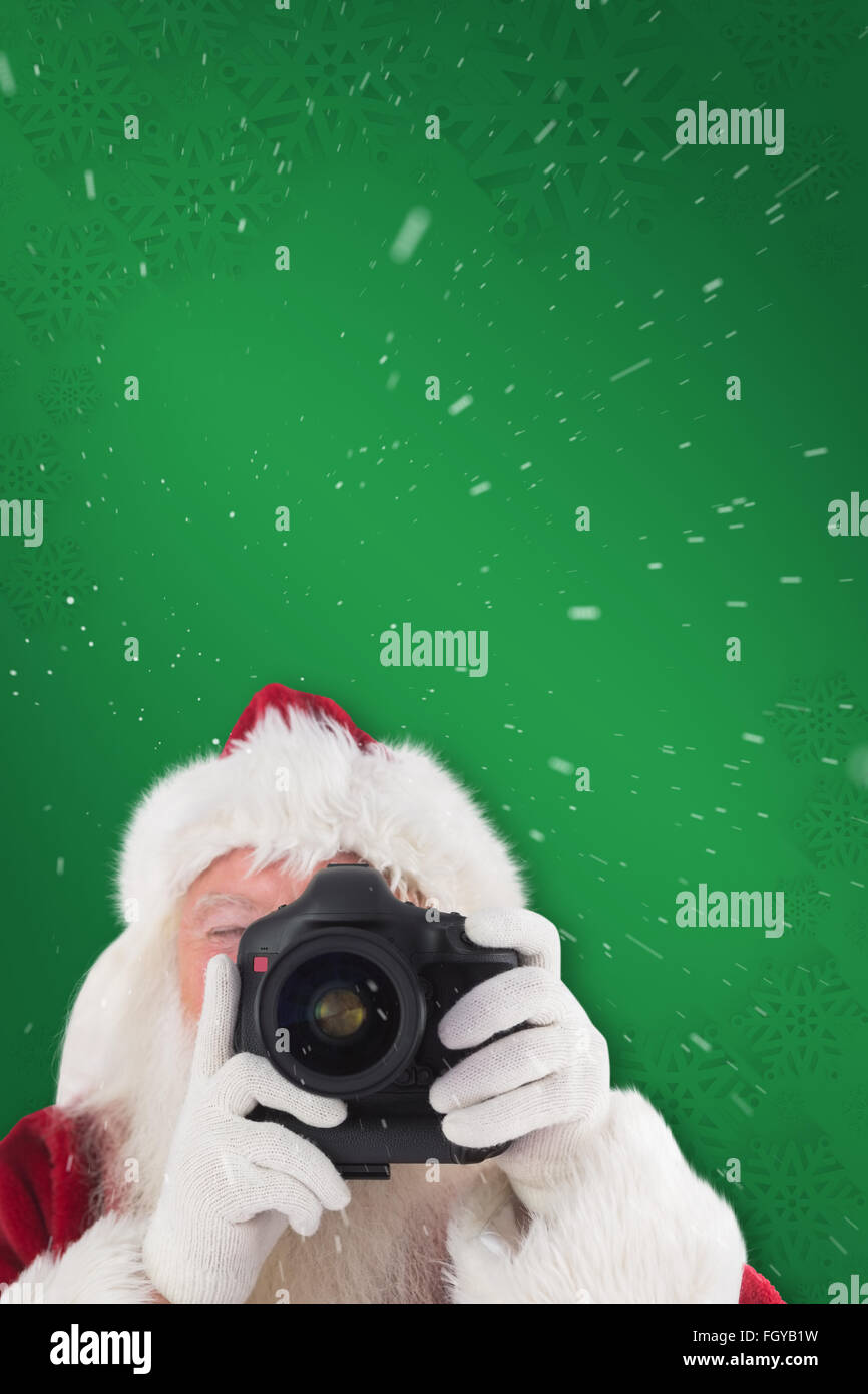 Composite image of santa is taking a picture Stock Photo - Alamy