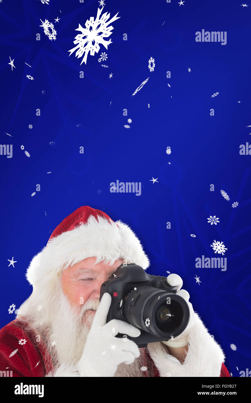 Composite image of santa is taking a picture Stock Photo - Alamy