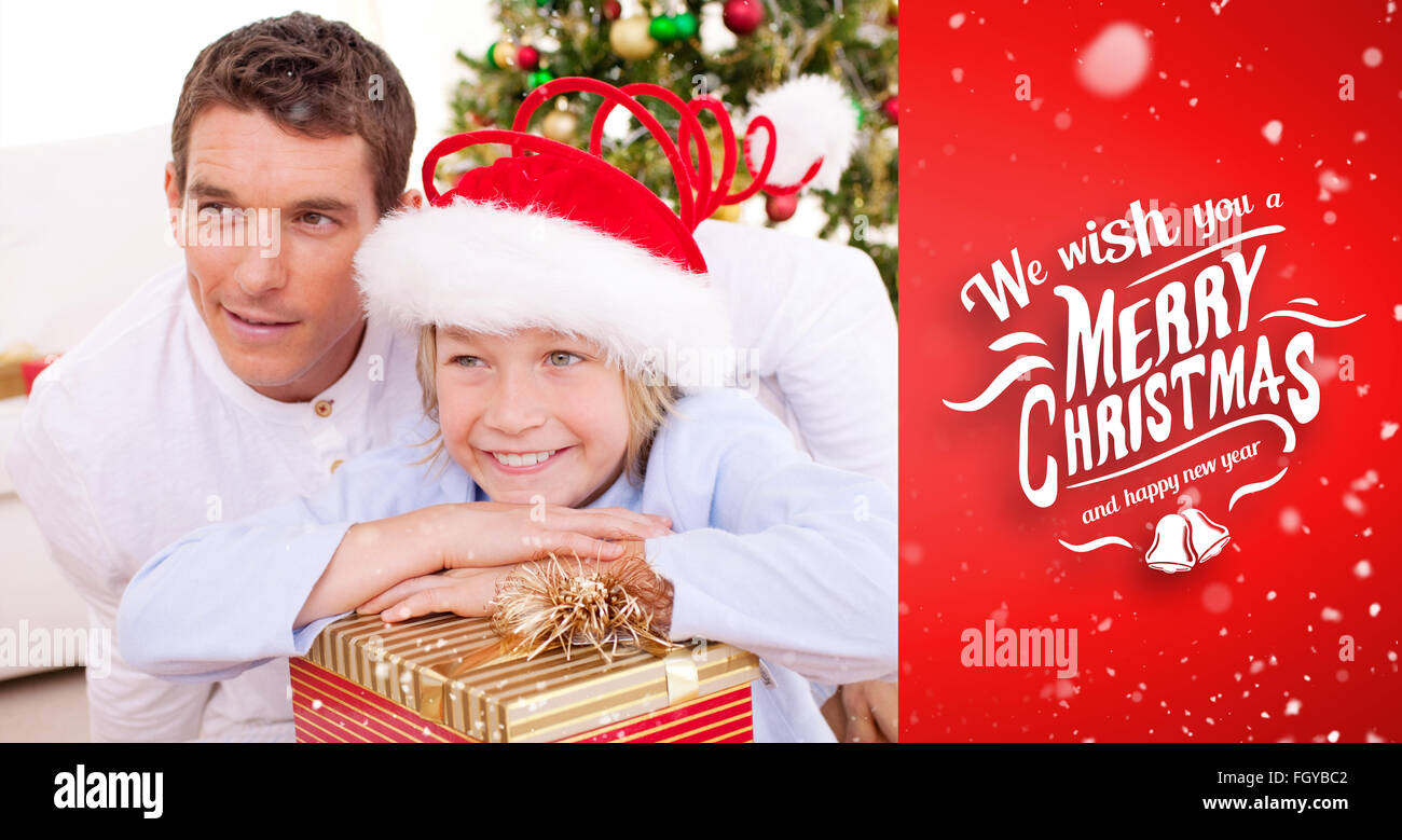 Composite image of smiling father and his son holding christmas gifts ...