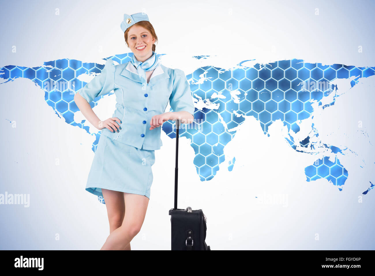 Composite image of pretty air hostess smiling at camera Stock Photo - Alamy