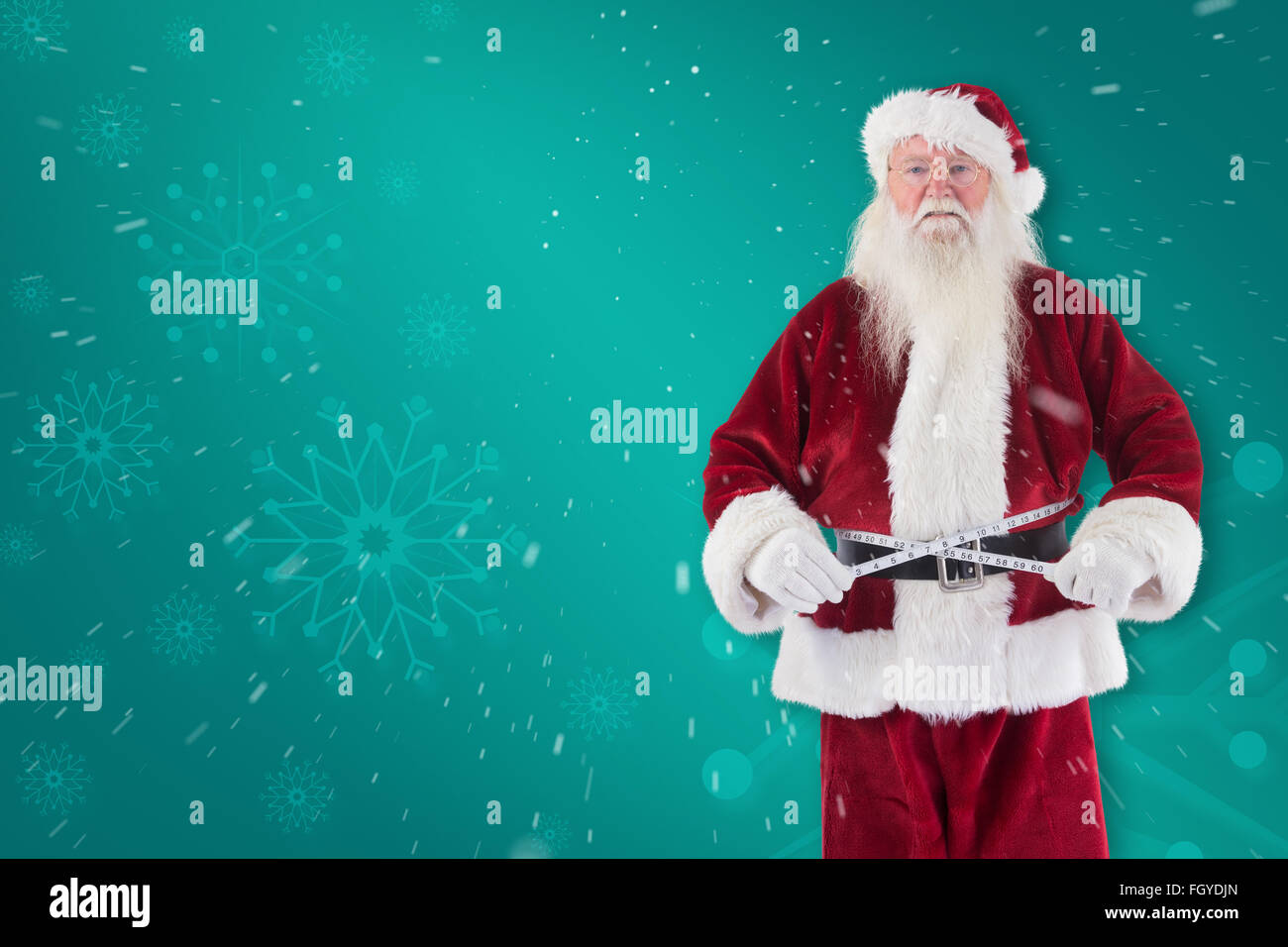 Composite image of santa claus measures his belly Stock Photo - Alamy