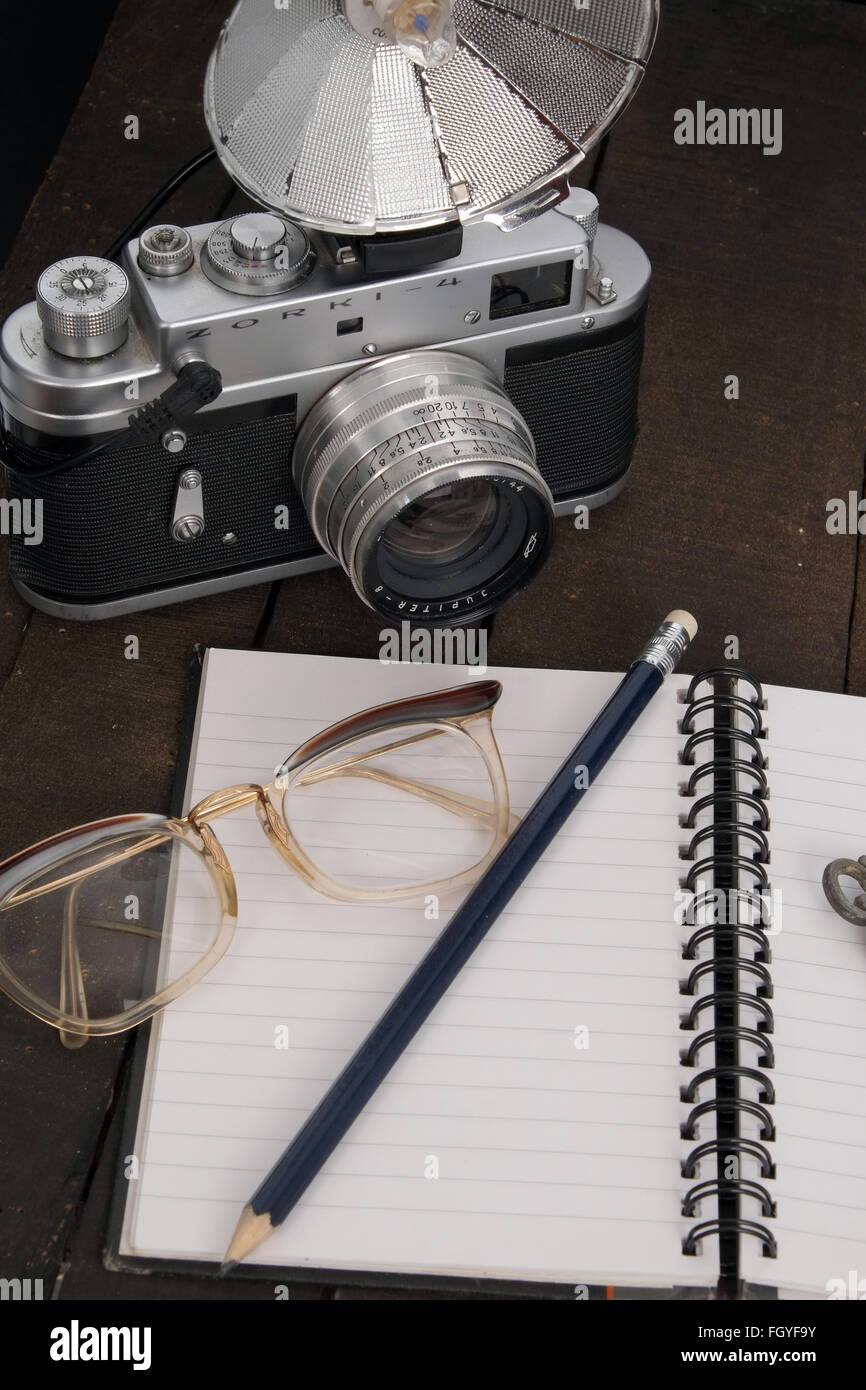 Concepts of a lady explorer , note book, old film camera, note book and ...