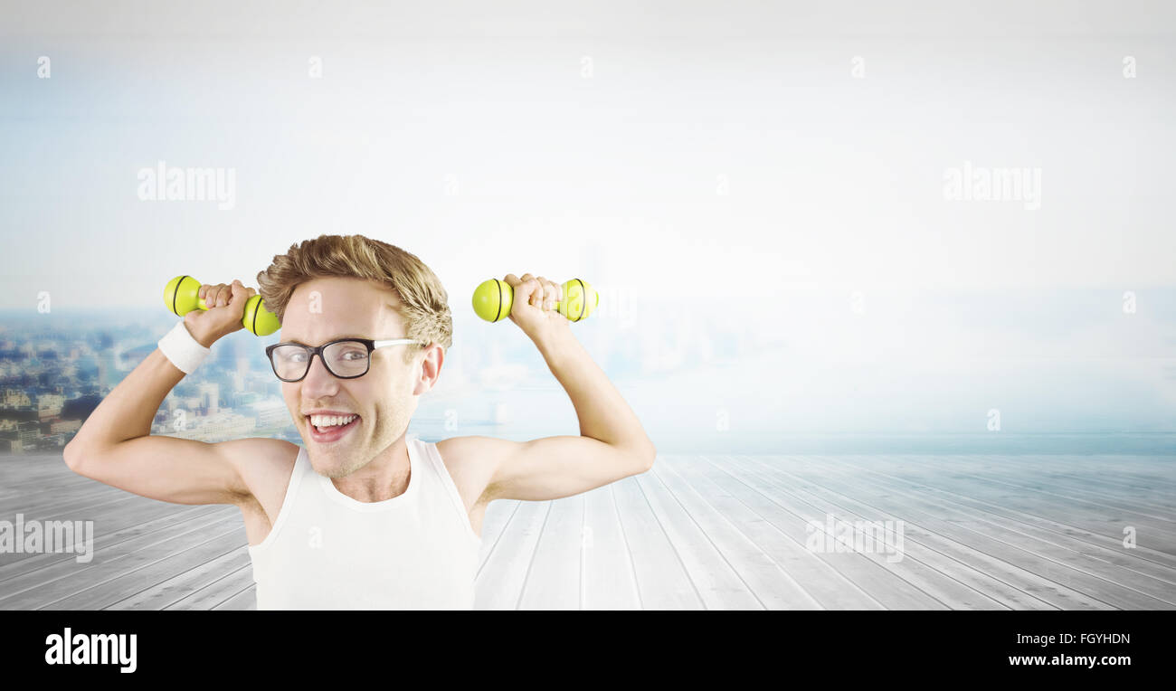 Composite image of nerd lifting weights Stock Photo - Alamy