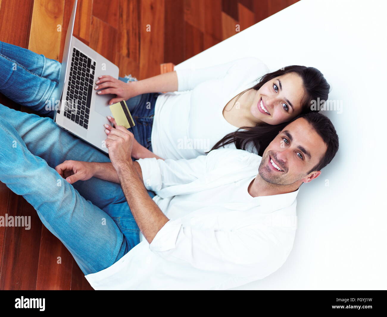 relaxed young couple working on laptop computer at home Stock Photo - Alamy