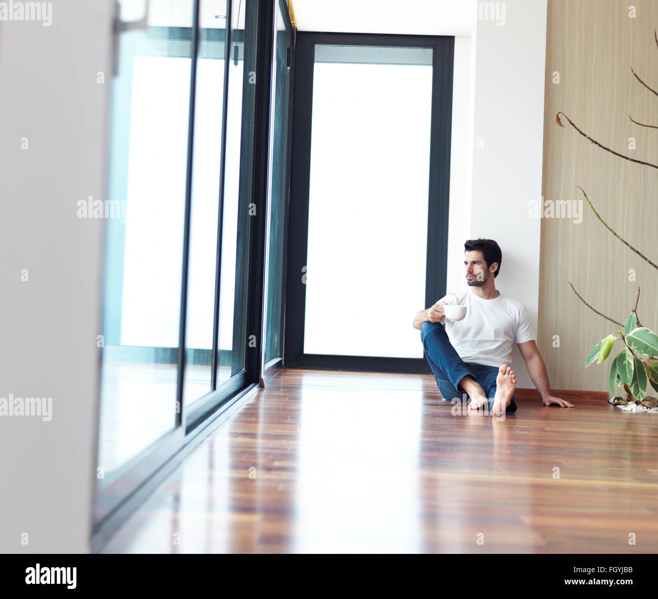 relaxed young man drink first morning coffee Stock Photo - Alamy