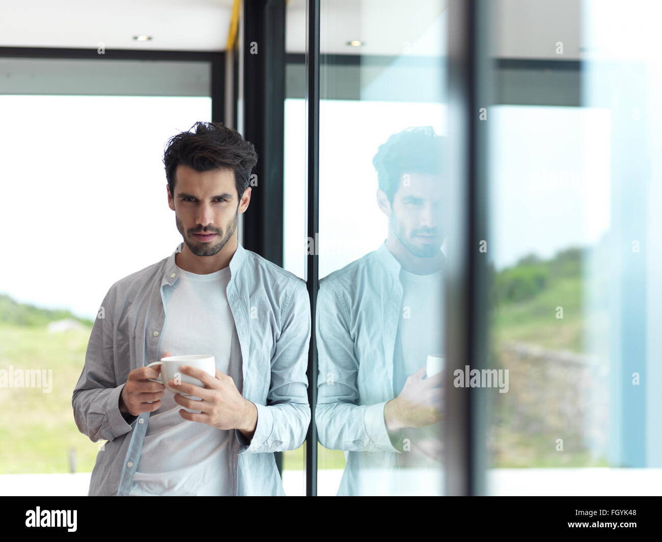 relaxed young man drink first morning coffee Stock Photo - Alamy