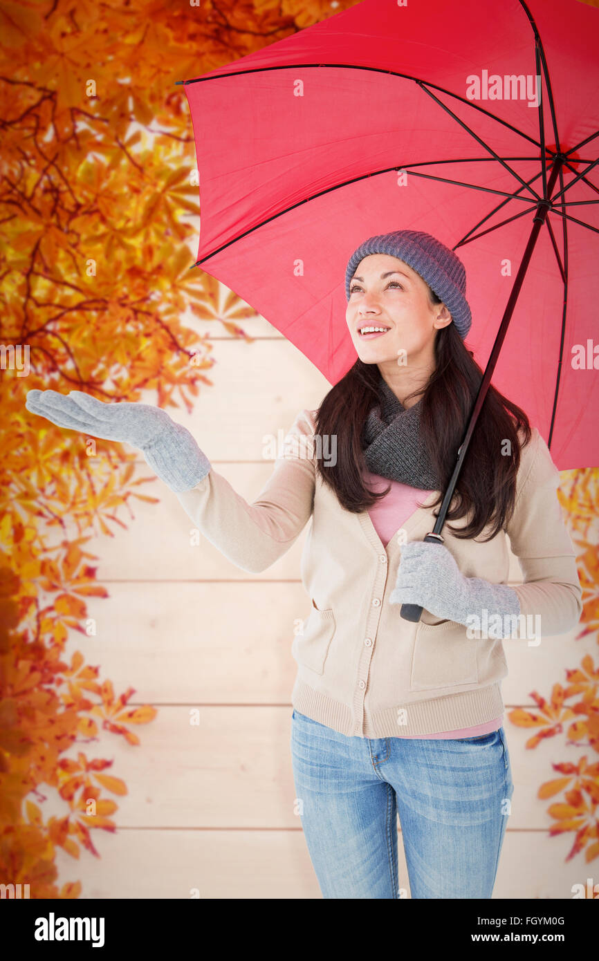 Composite image of smiling brunette feeling the rain Stock Photo - Alamy
