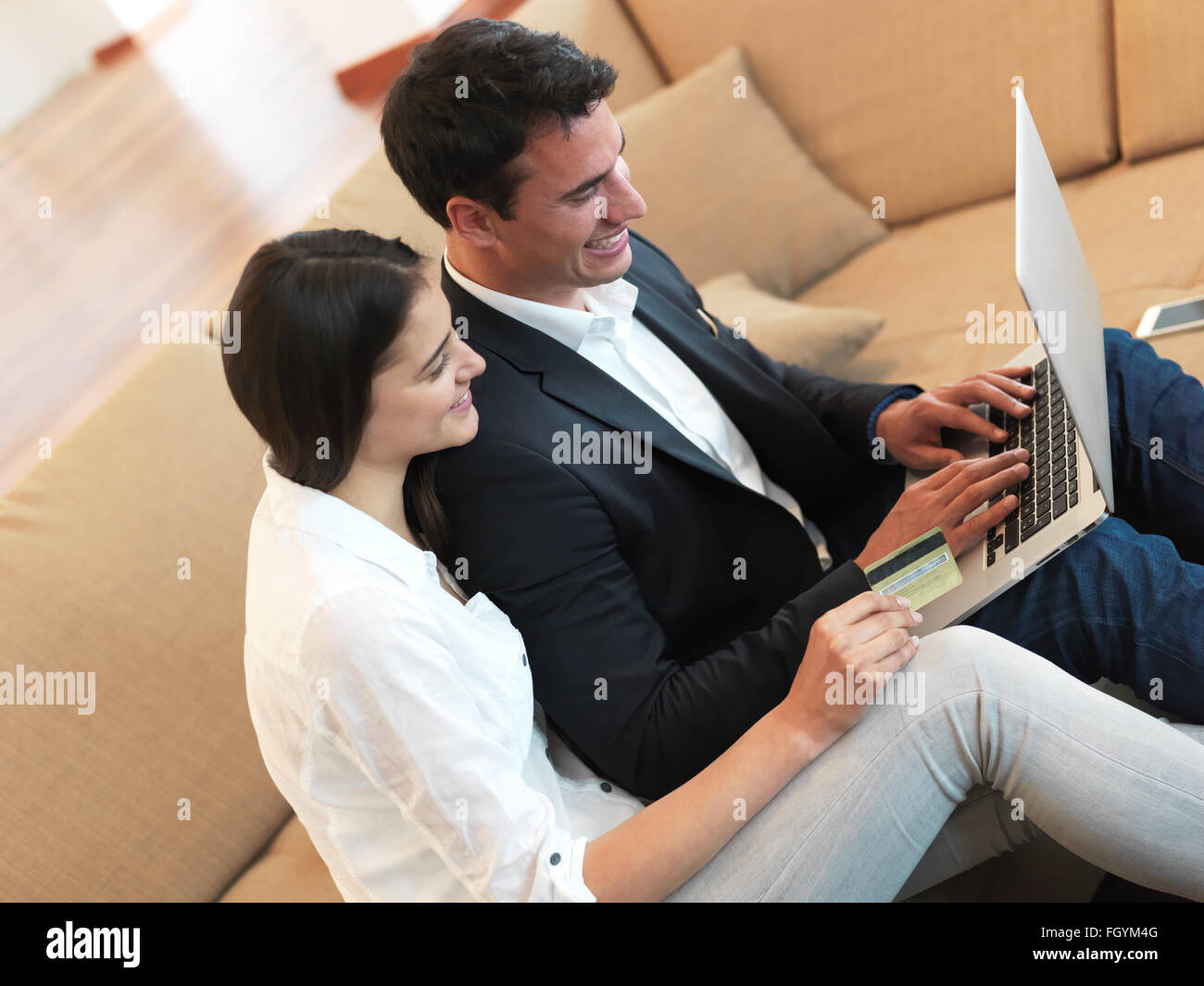 relaxed young couple working on laptop computer at home Stock Photo - Alamy