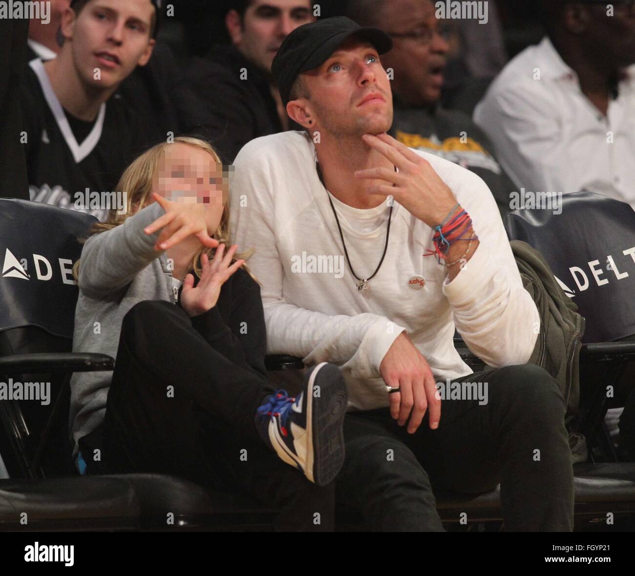 Chris Martin and his son Moses Martin watch the Sacramento Kings defeat ...