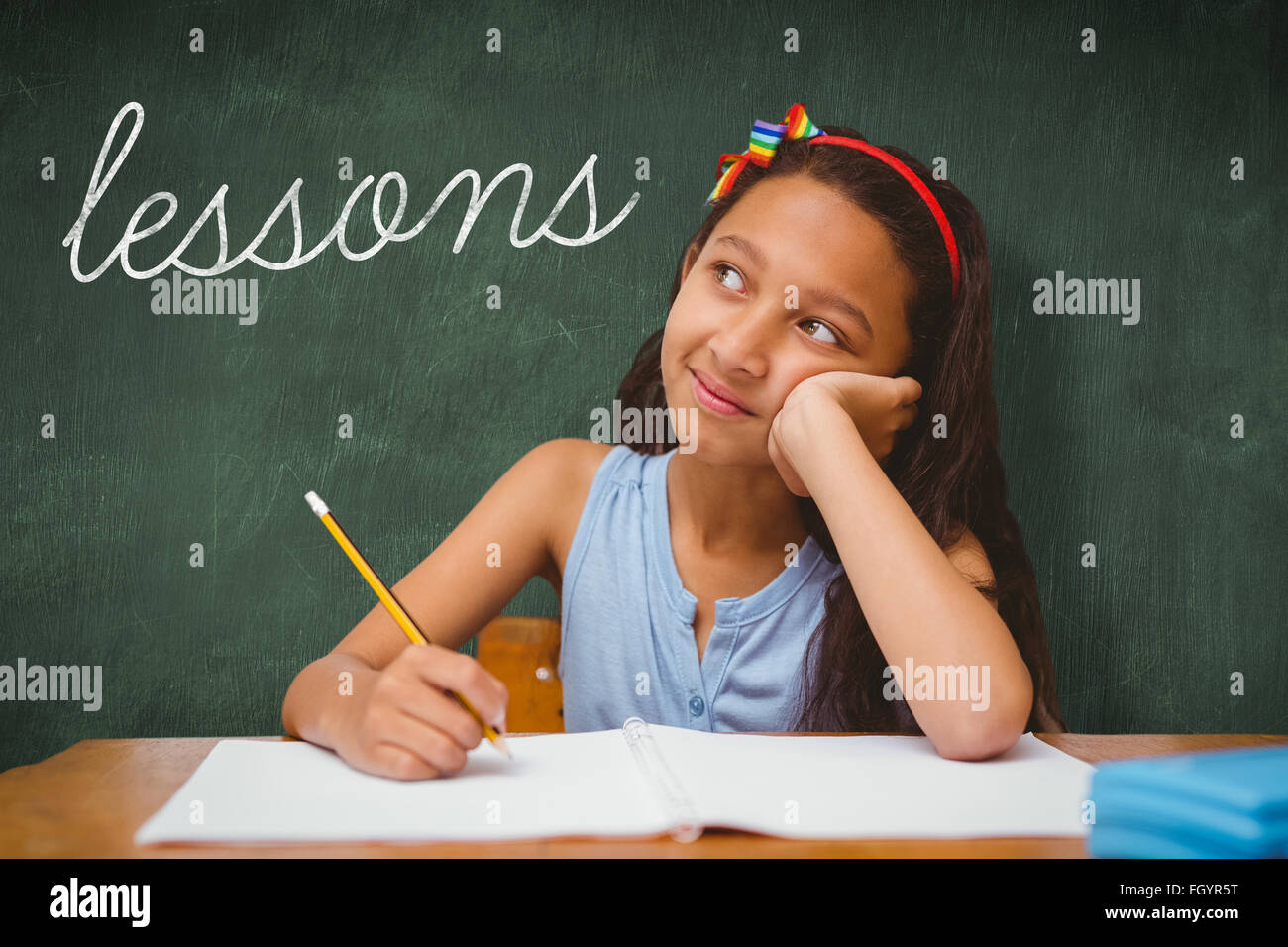 Lessons against green chalkboard Stock Photo - Alamy