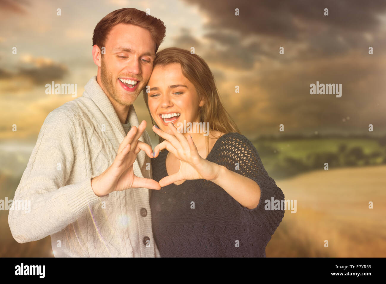 Composite image of happy couple forming heart with hands Stock Photo ...