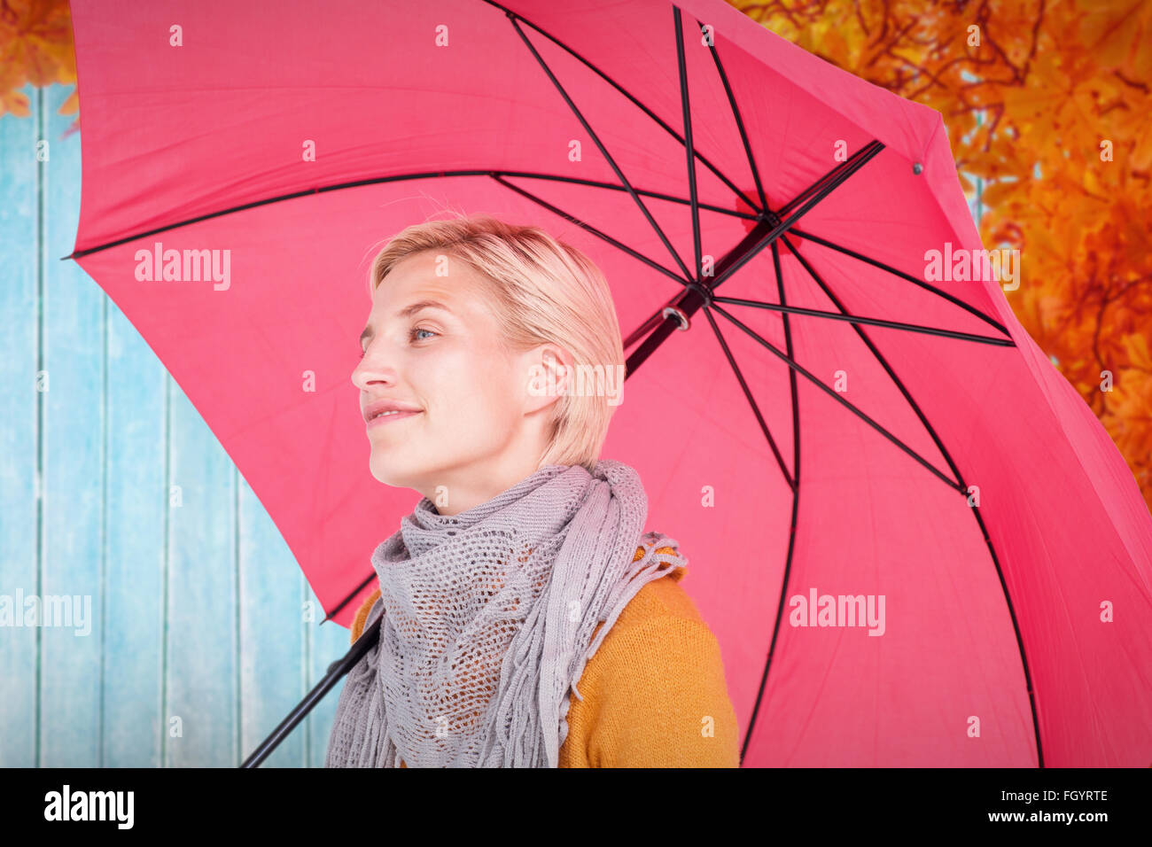 Composite image of happy woman keeping dry Stock Photo - Alamy