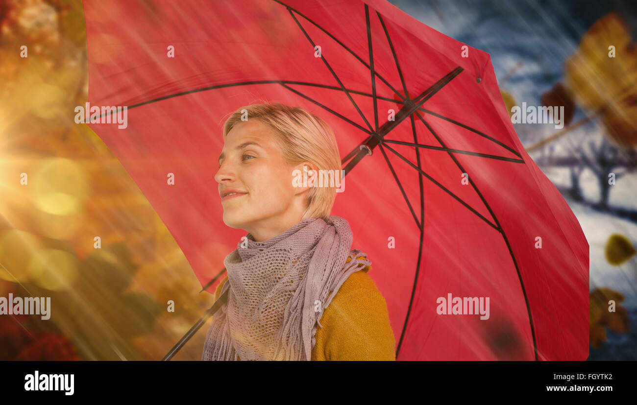 Composite image of happy woman keeping dry Stock Photo - Alamy