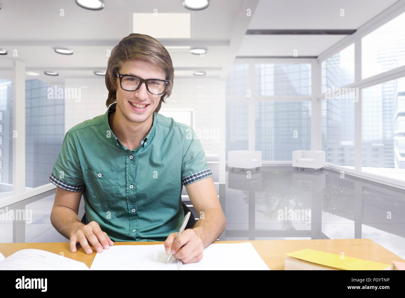 Composite image of student sitting in library writing Stock Photo - Alamy