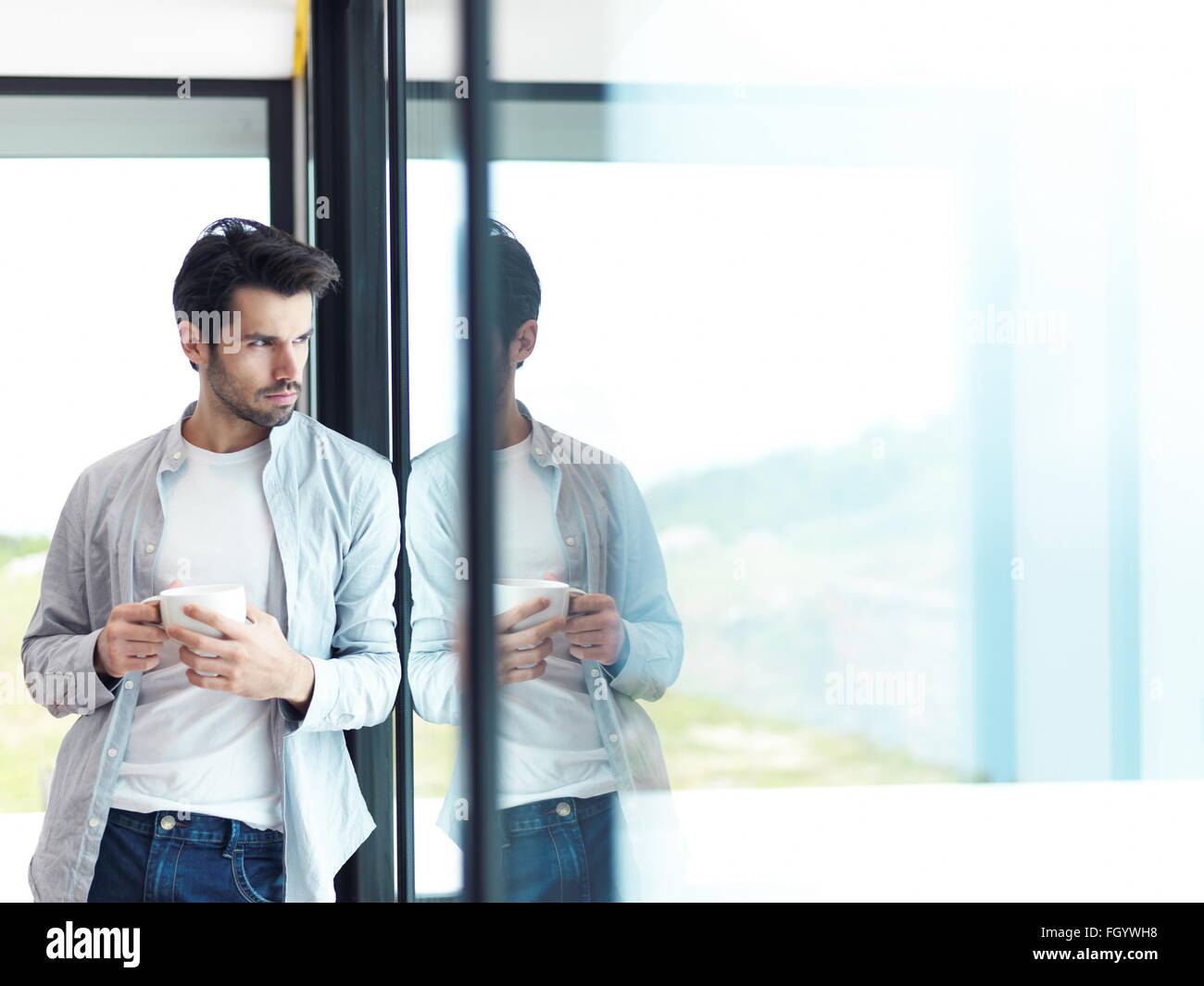 relaxed young man drink first morning coffee Stock Photo - Alamy