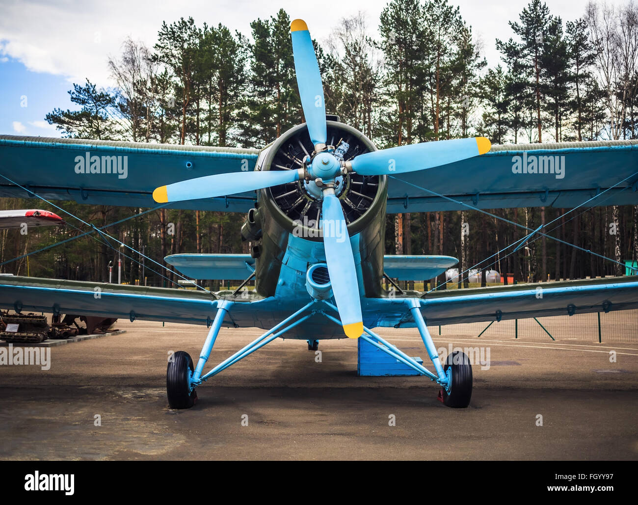 Blue airplane with propeller. Vintage biplane. Front view, with the ...