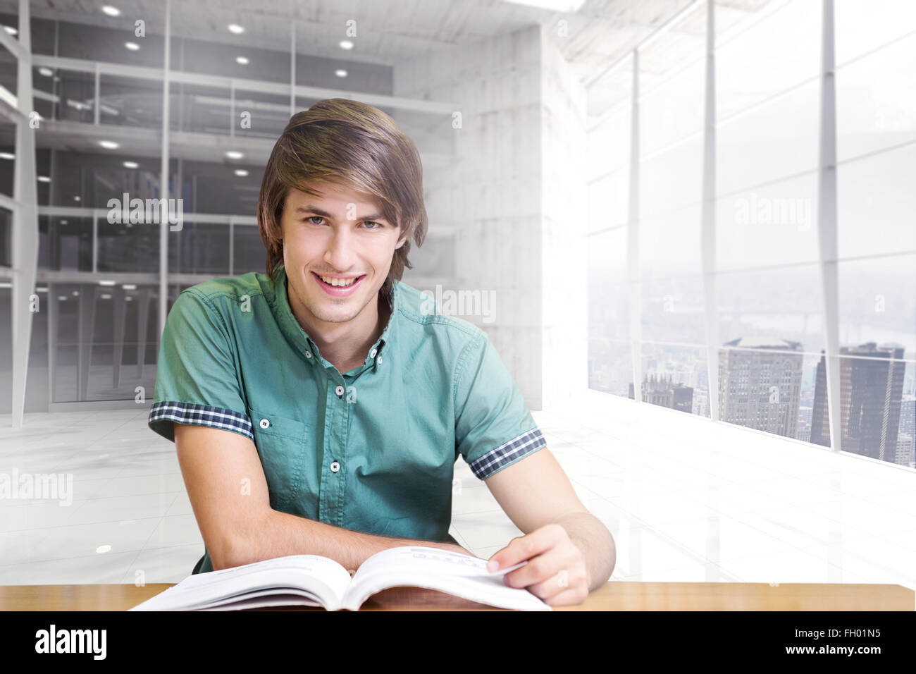 Composite image of student sitting in library reading Stock Photo - Alamy