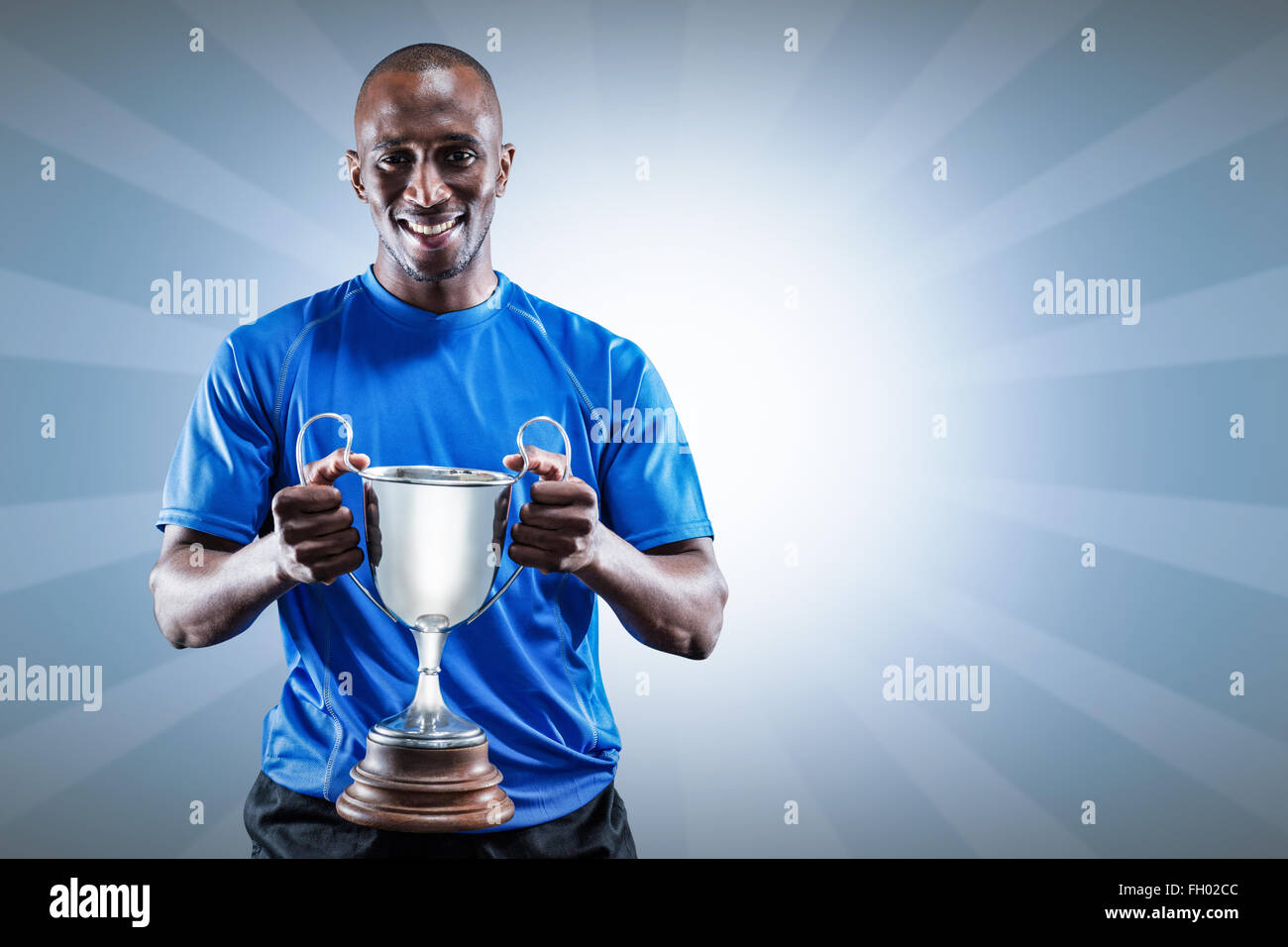 Composite image of portrait of happy athlete holding trophy Stock Photo ...