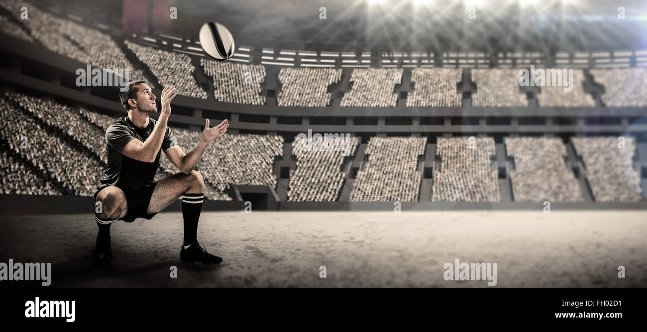 Composite image of full length of rugby player catching the ball Stock ...