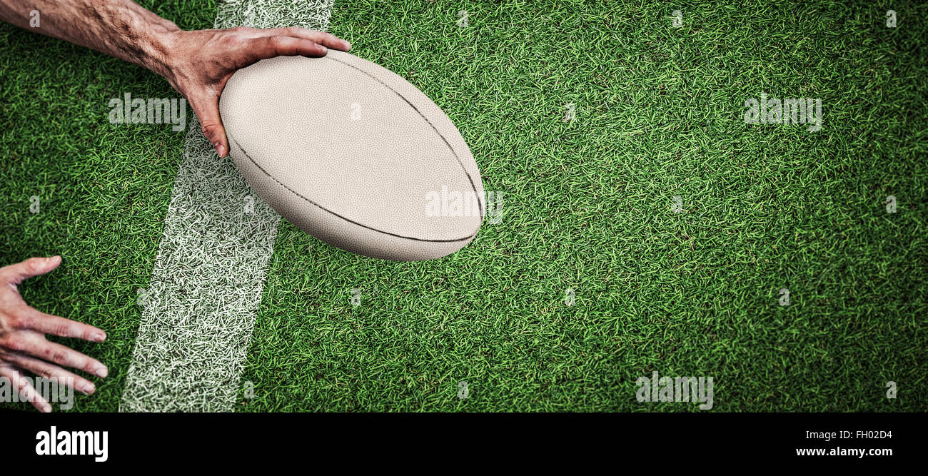 Composite image of cropped image of a man holding rugby ball Stock ...