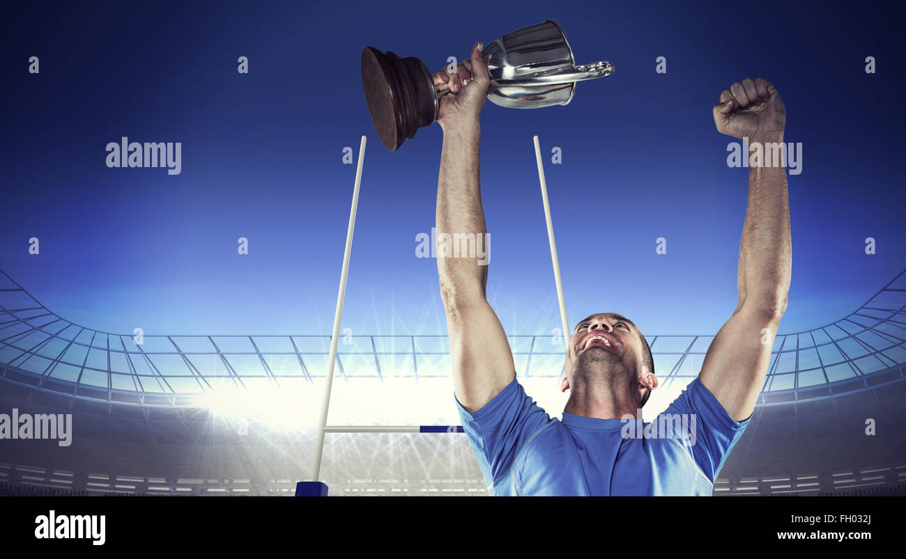 Composite image of happy rugby player holding trophy Stock Photo - Alamy