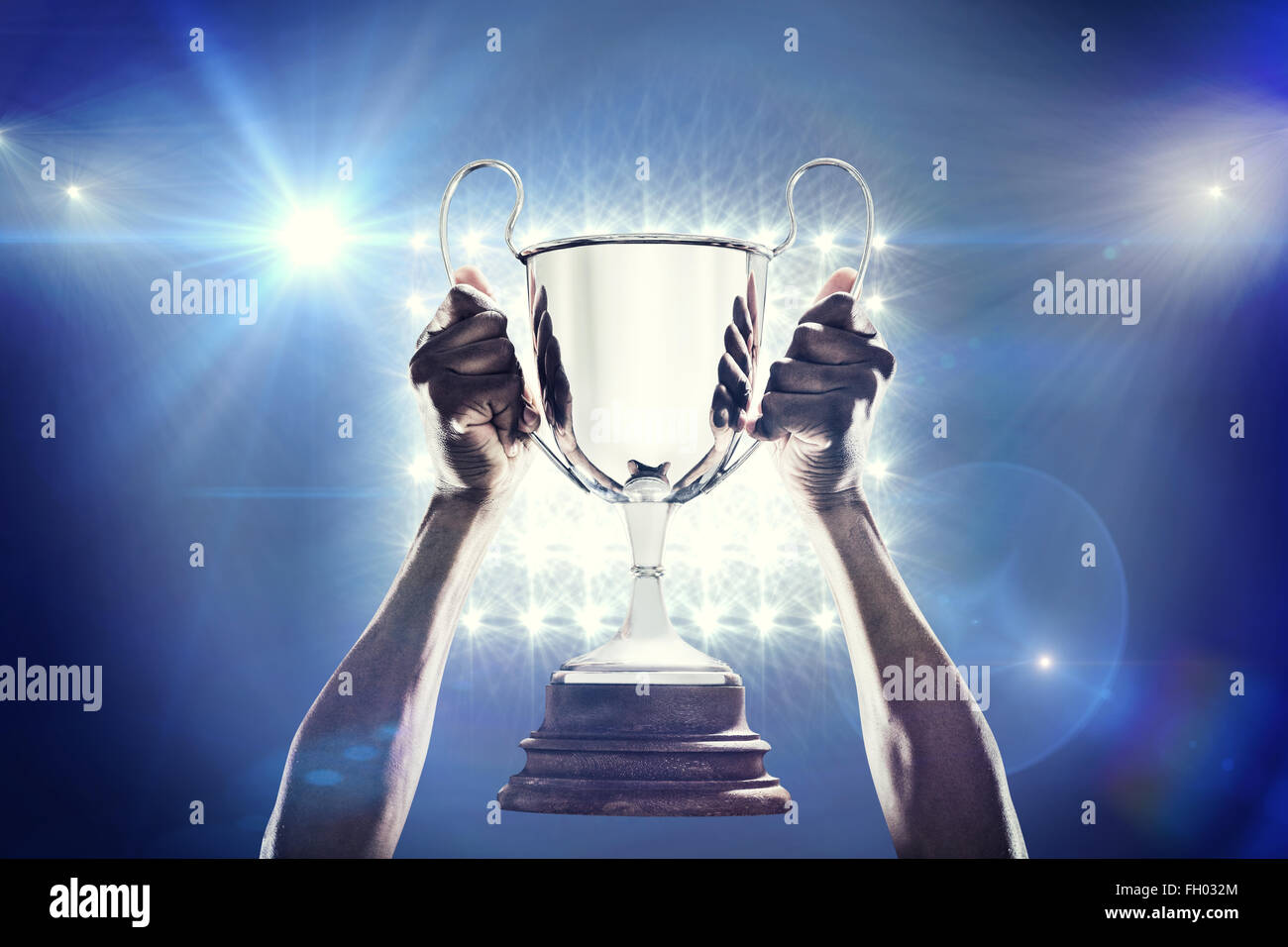 Composite image of cropped hand of athlete holding trophy Stock Photo ...
