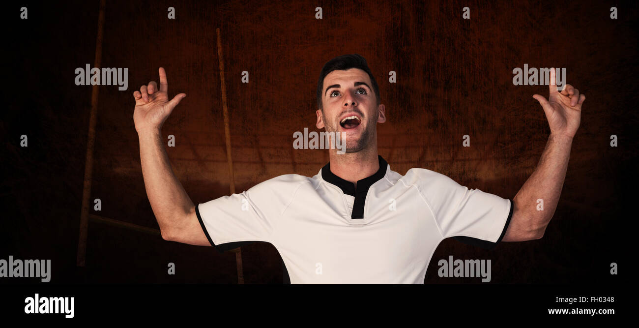 Composite image of surprised rugby player pointing up Stock Photo - Alamy