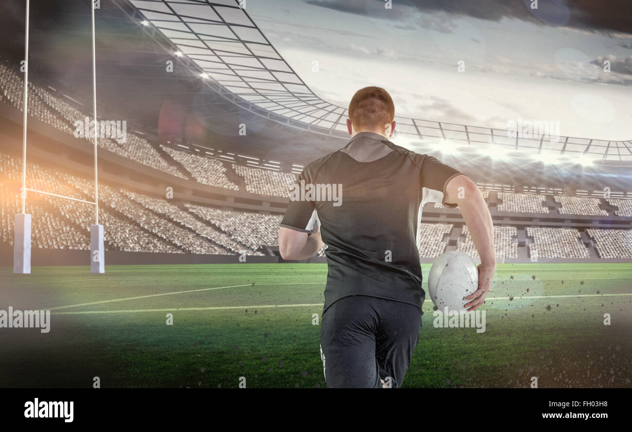 Composite image of rugby player running with a rugby ball Stock Photo ...