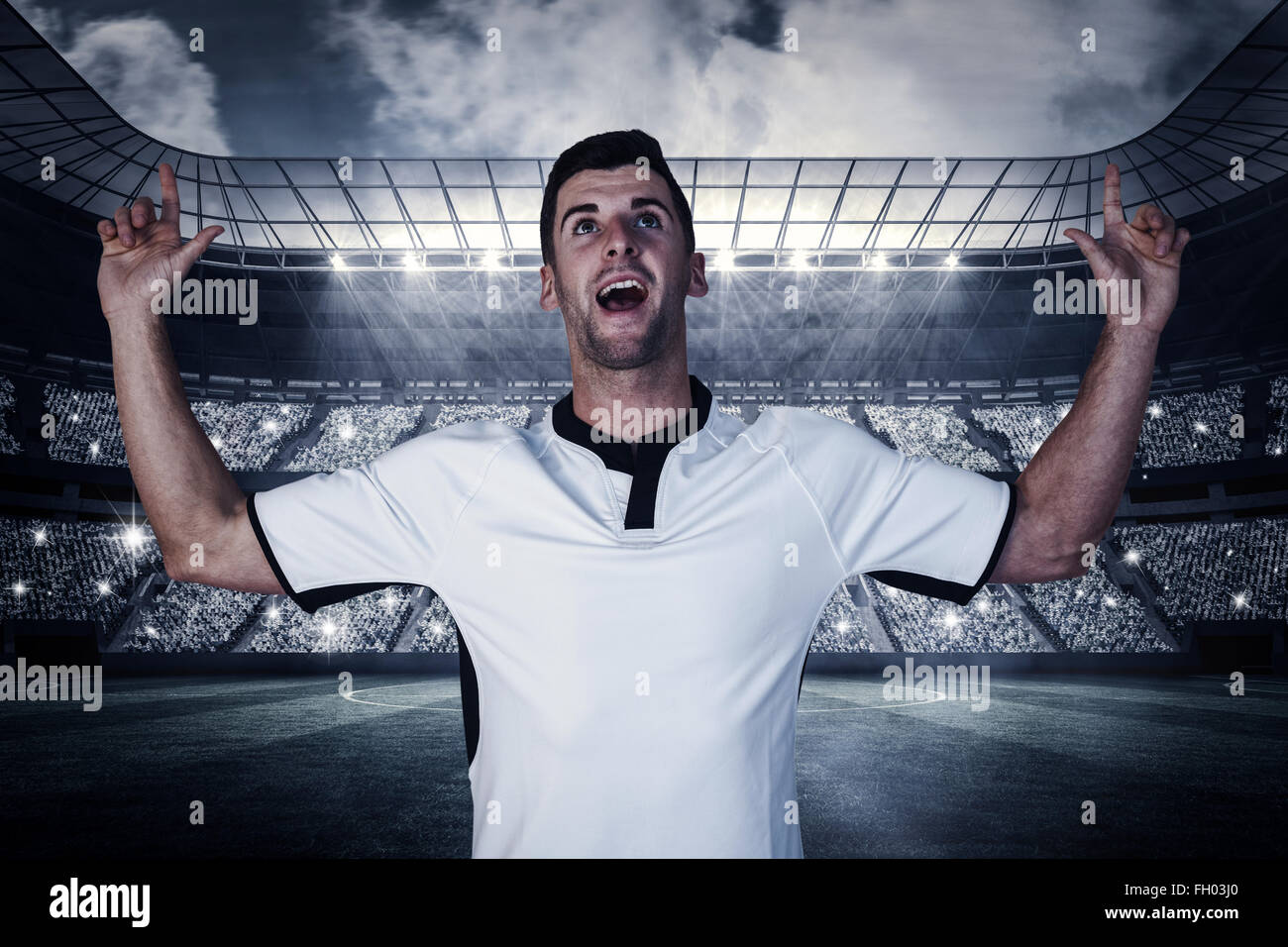 Composite image of surprised rugby player pointing up Stock Photo - Alamy