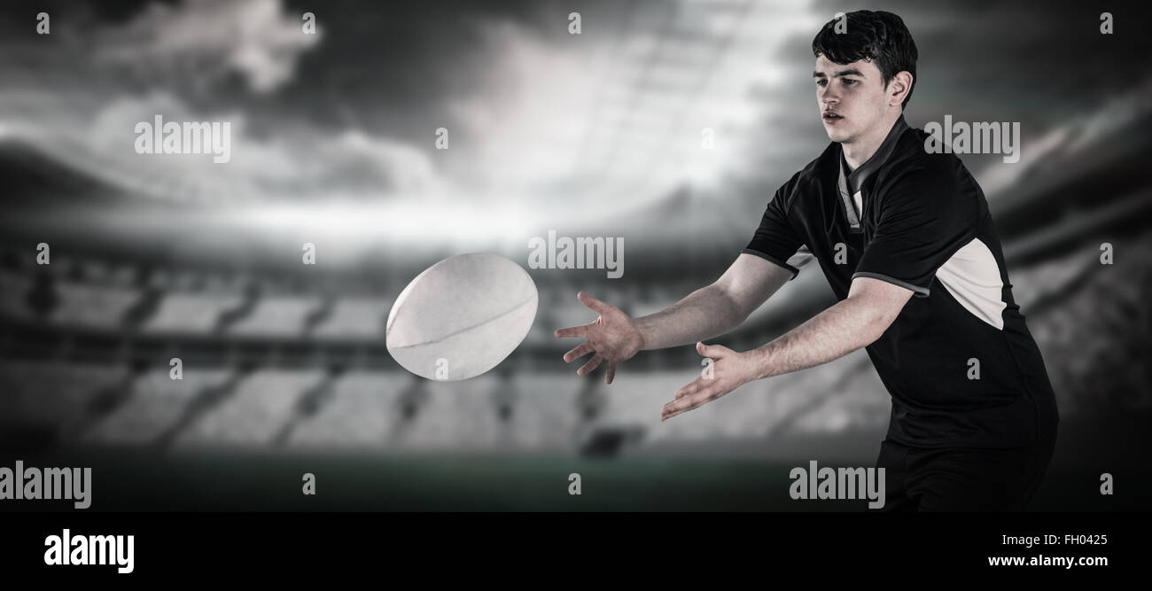 Composite image of rugby player throwing a rugby ball Stock Photo - Alamy