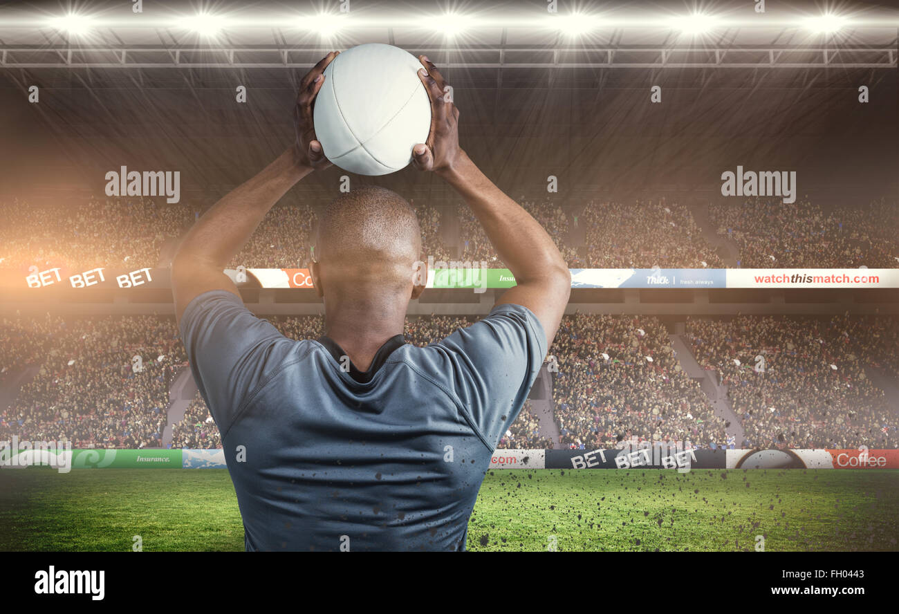 Composite image of rear view of athlete throwing rugby ball Stock Photo ...