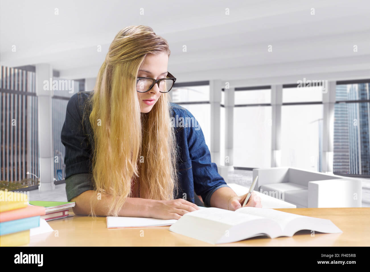 Composite image of student studying in the library Stock Photo - Alamy