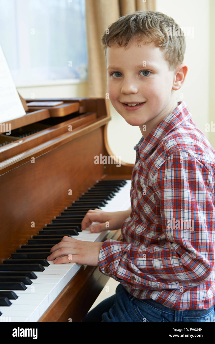 Portrait Of Young Boy Playing Piano At Home Stock Photo - Alamy