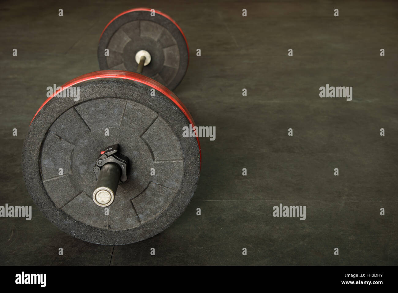 Barbell with black and red weight plates Stock Photo - Alamy