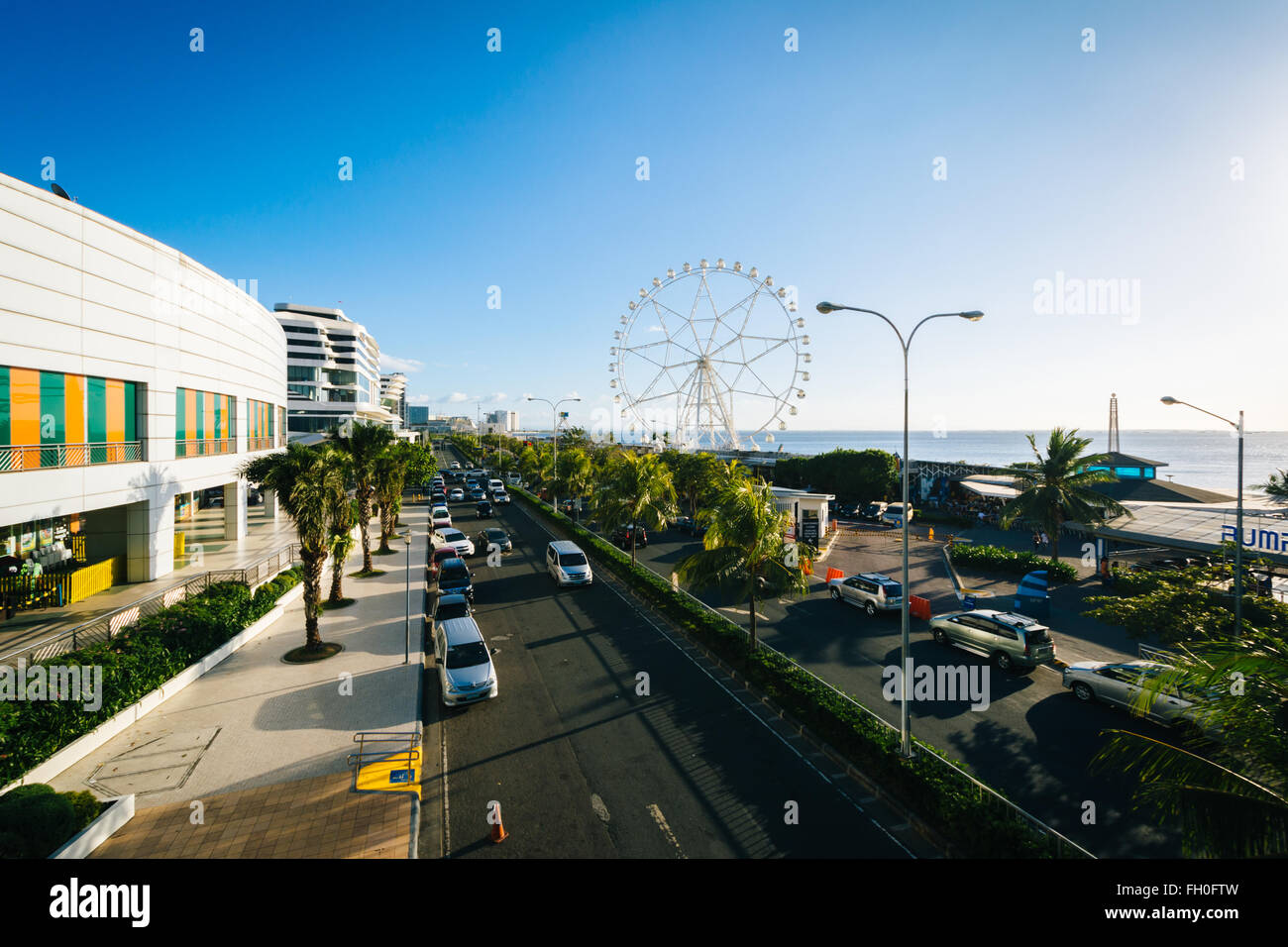 The exterior of the Mall of Asia and ferris wheel, in Pasay, Metro ...