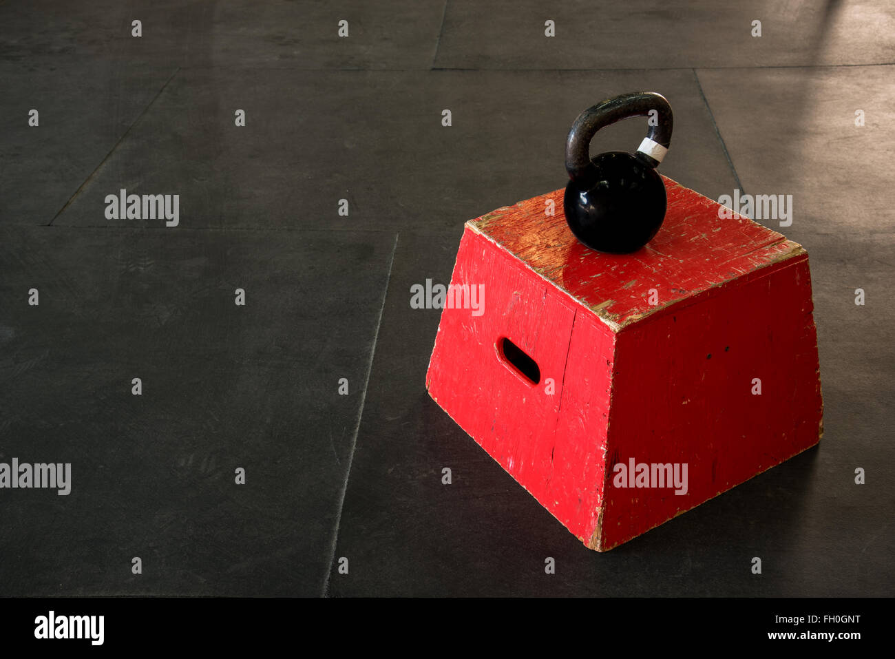 Red jump box with a black kettle bell Stock Photo - Alamy