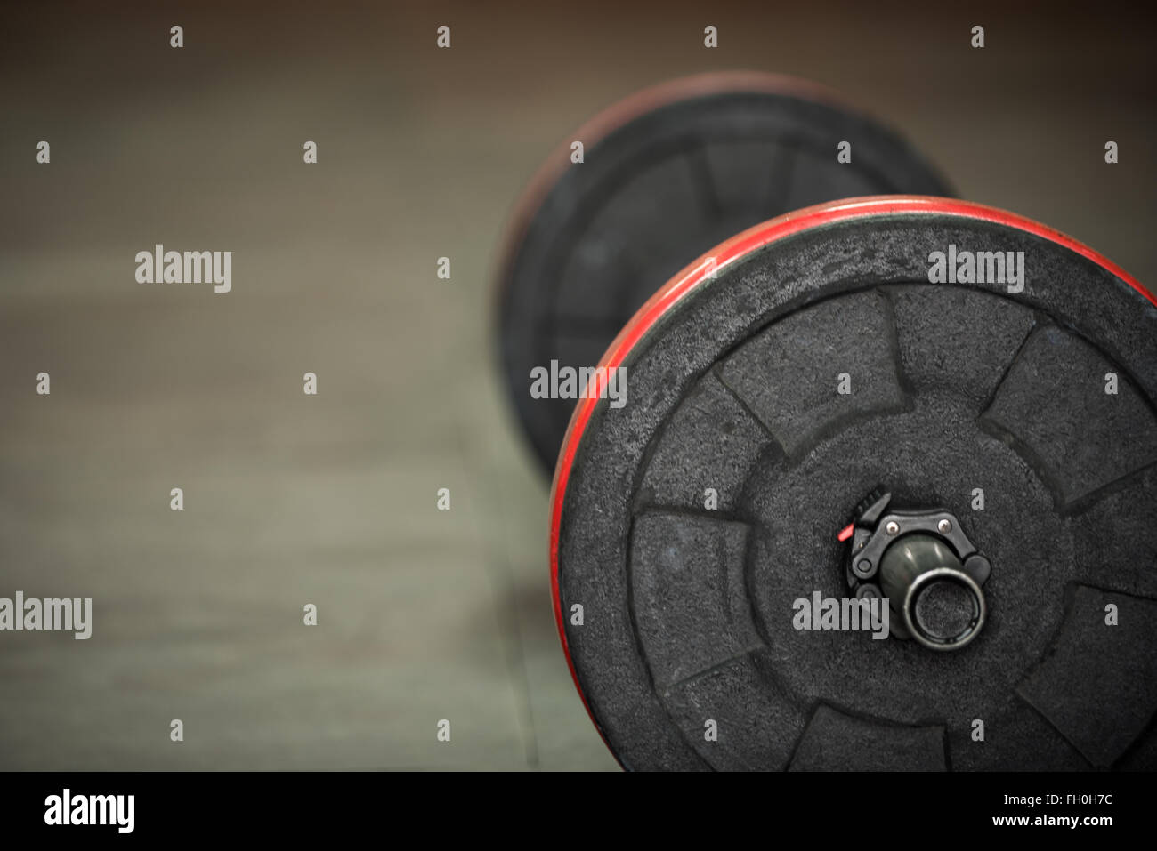 Barbell with black and red weight plates Stock Photo - Alamy