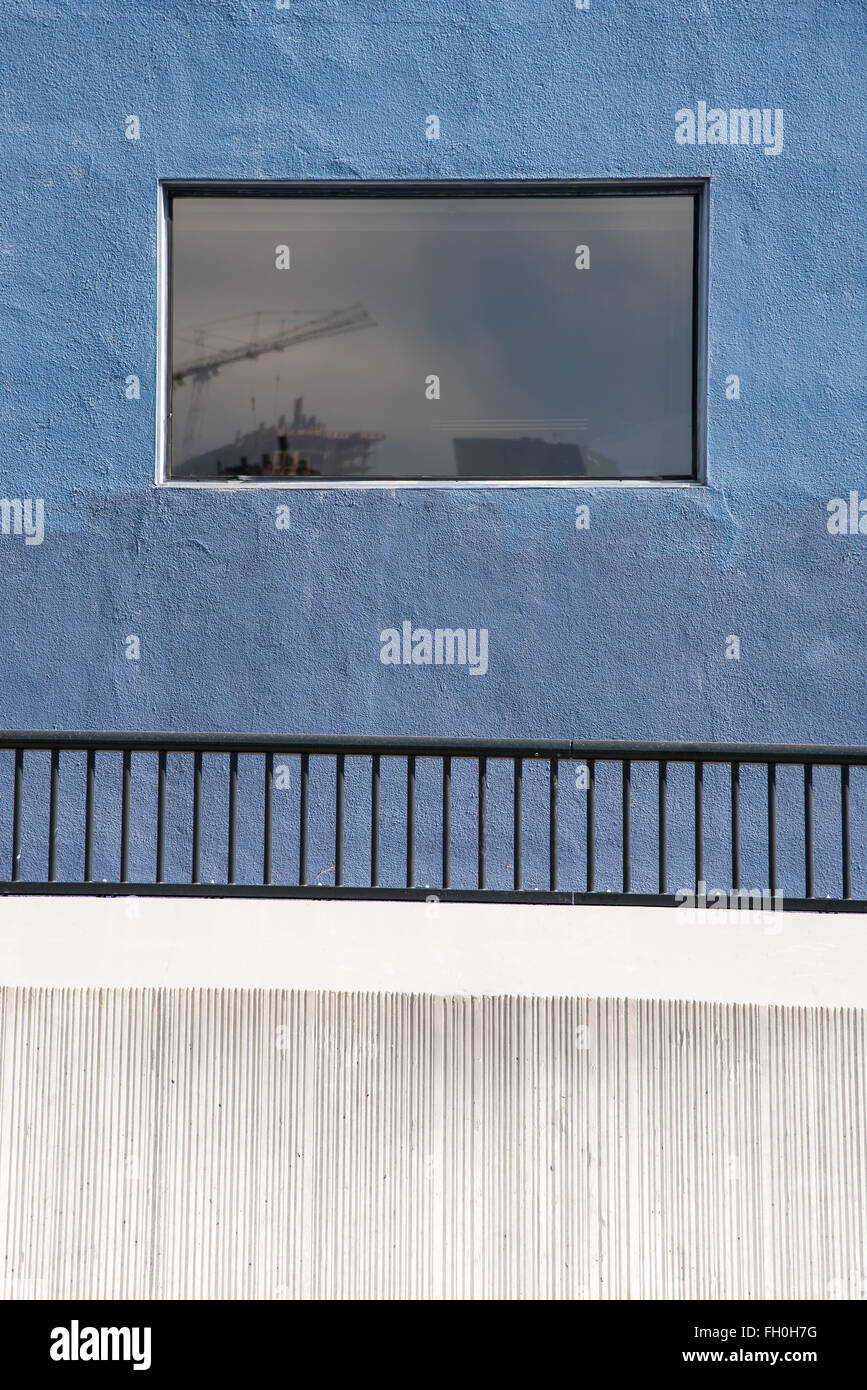 Blue and wall with window showing reflection Stock Photo - Alamy