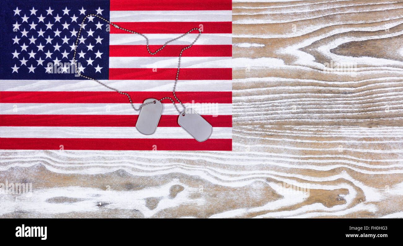 Overhead view of a United of America flag and military ID tags, in ...