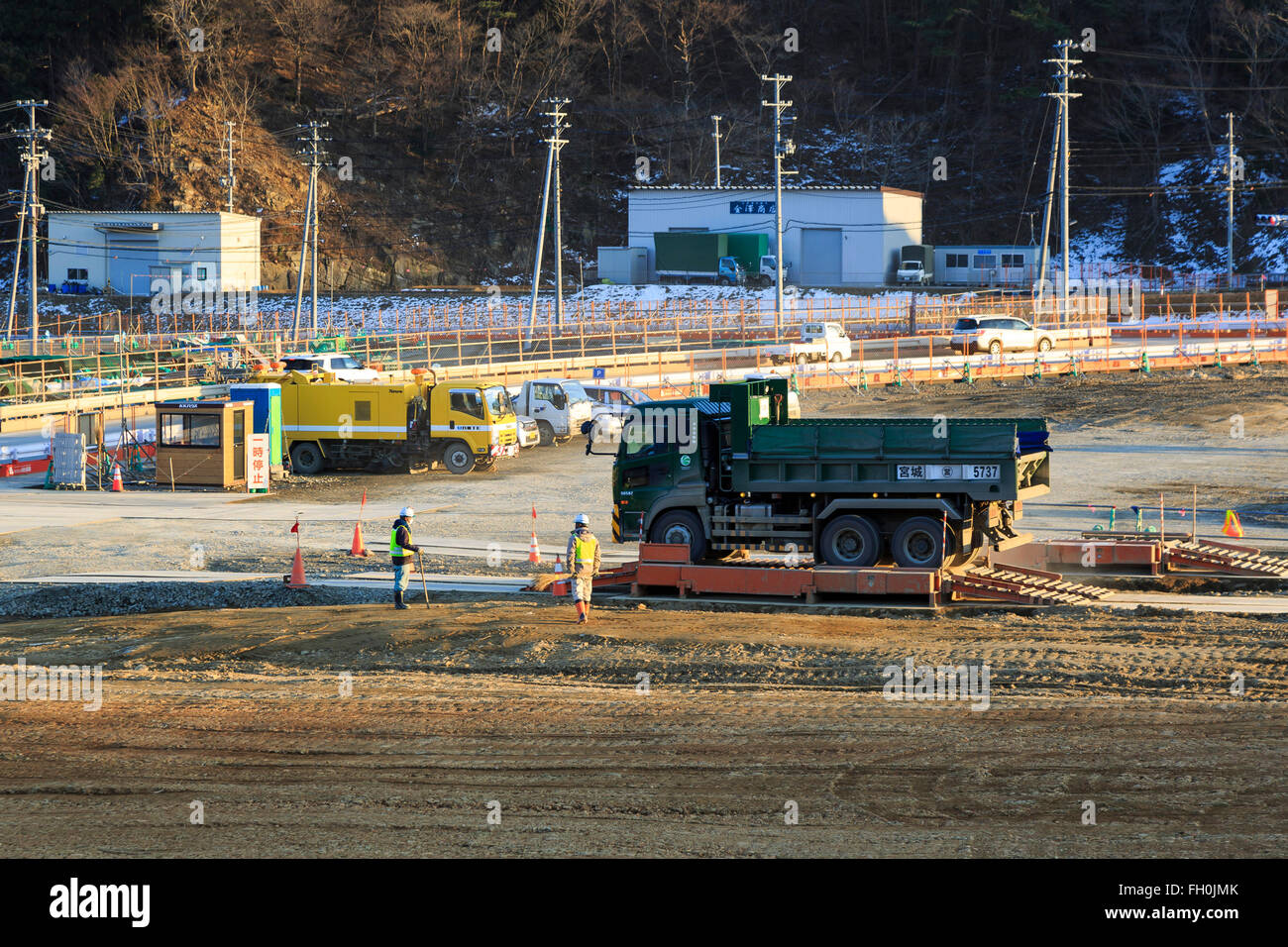 Construction trucks and bulldozers still work on the damaged zones by ...