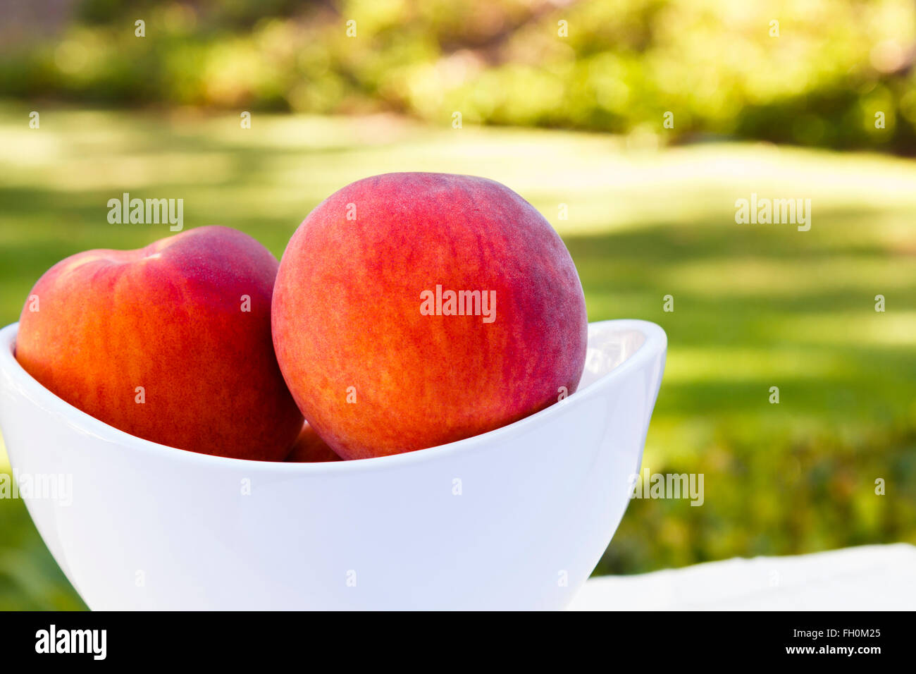 A bowl of peaches in a backyard setting Stock Photo - Alamy