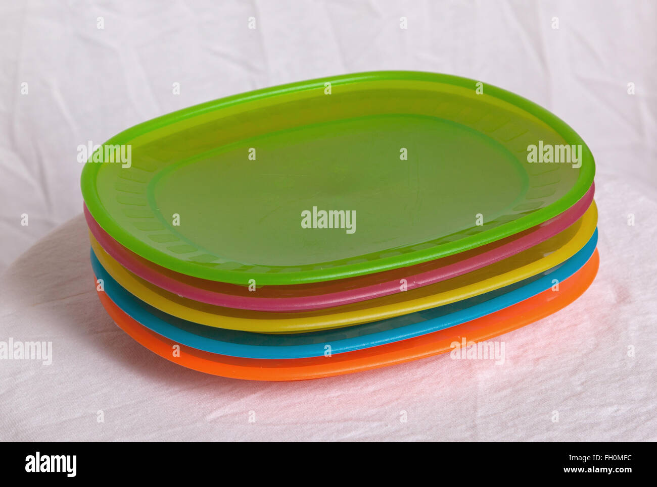 Colorful plastic plates closeup isolated on white background Stock ...