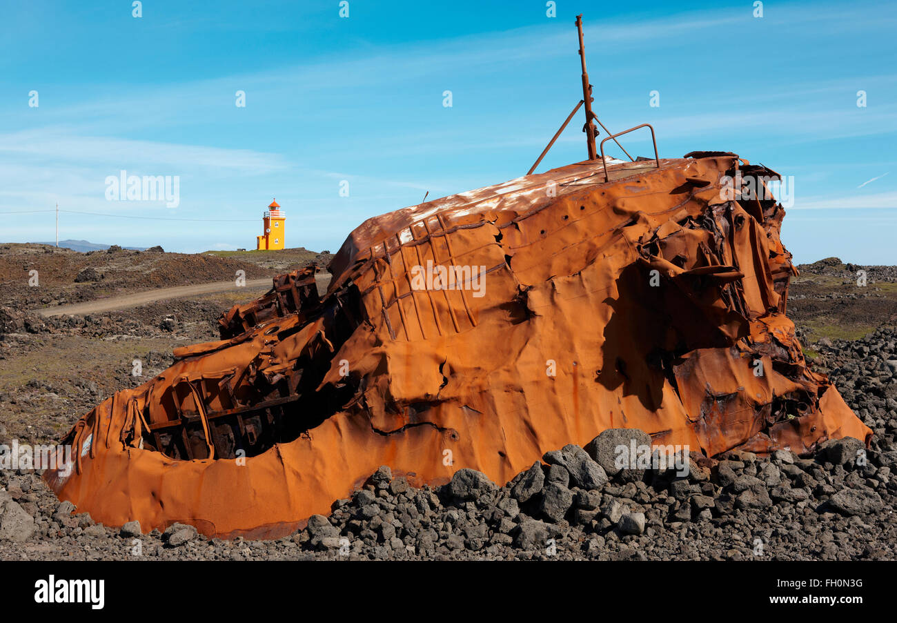 Icelandic landscape with rusted vessel and a lighthouse. Shipwreck ...