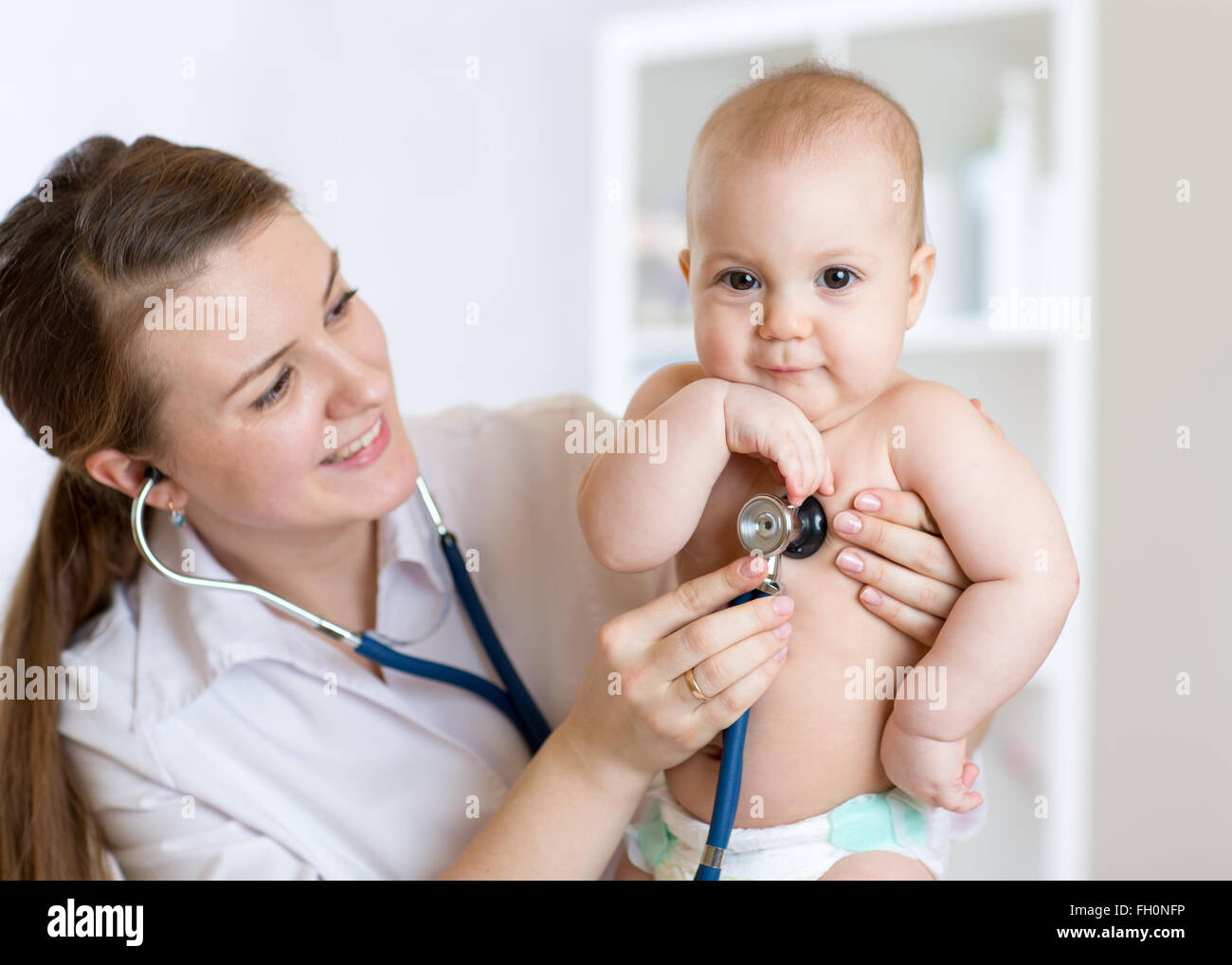 female pediatrician examining of child in hospital Stock Photo - Alamy